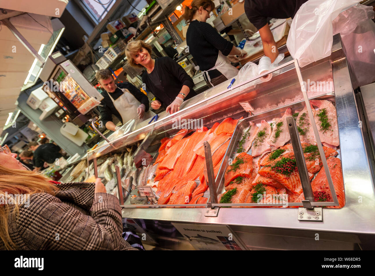Customer buying fish in a Smoked salmon in a fishmonger in Kauppahalli ...