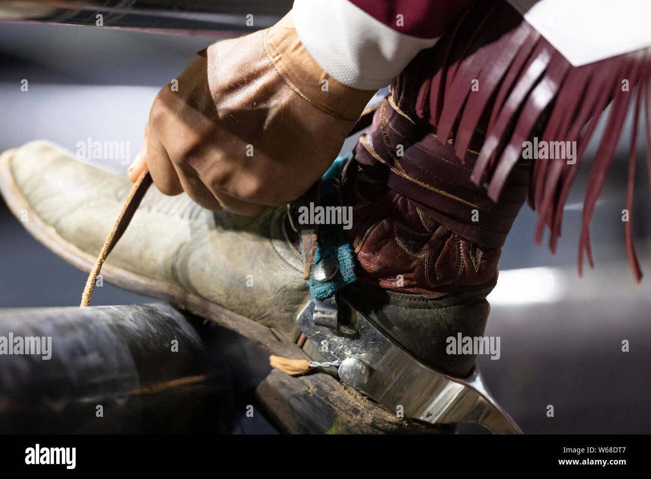 A close up of a cowboy boot and spur on a pipe Stock Photo - Alamy