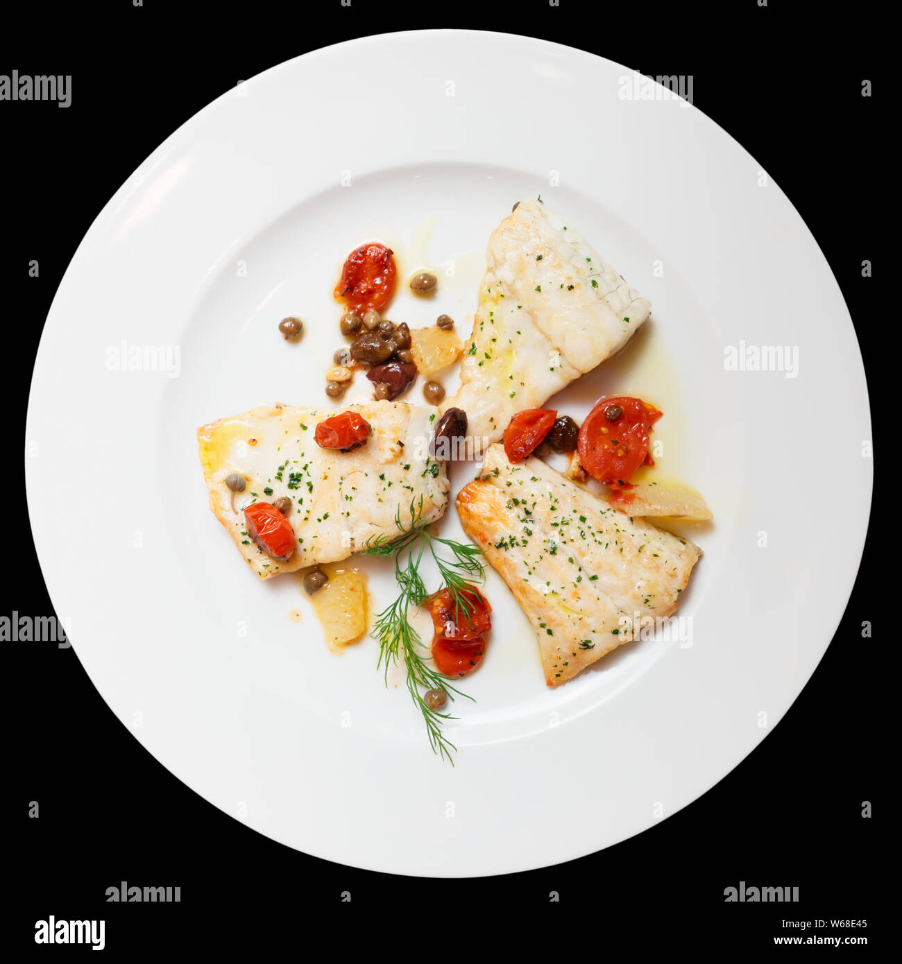 Fried fish fillet with capers isolated on black background Stock Photo ...