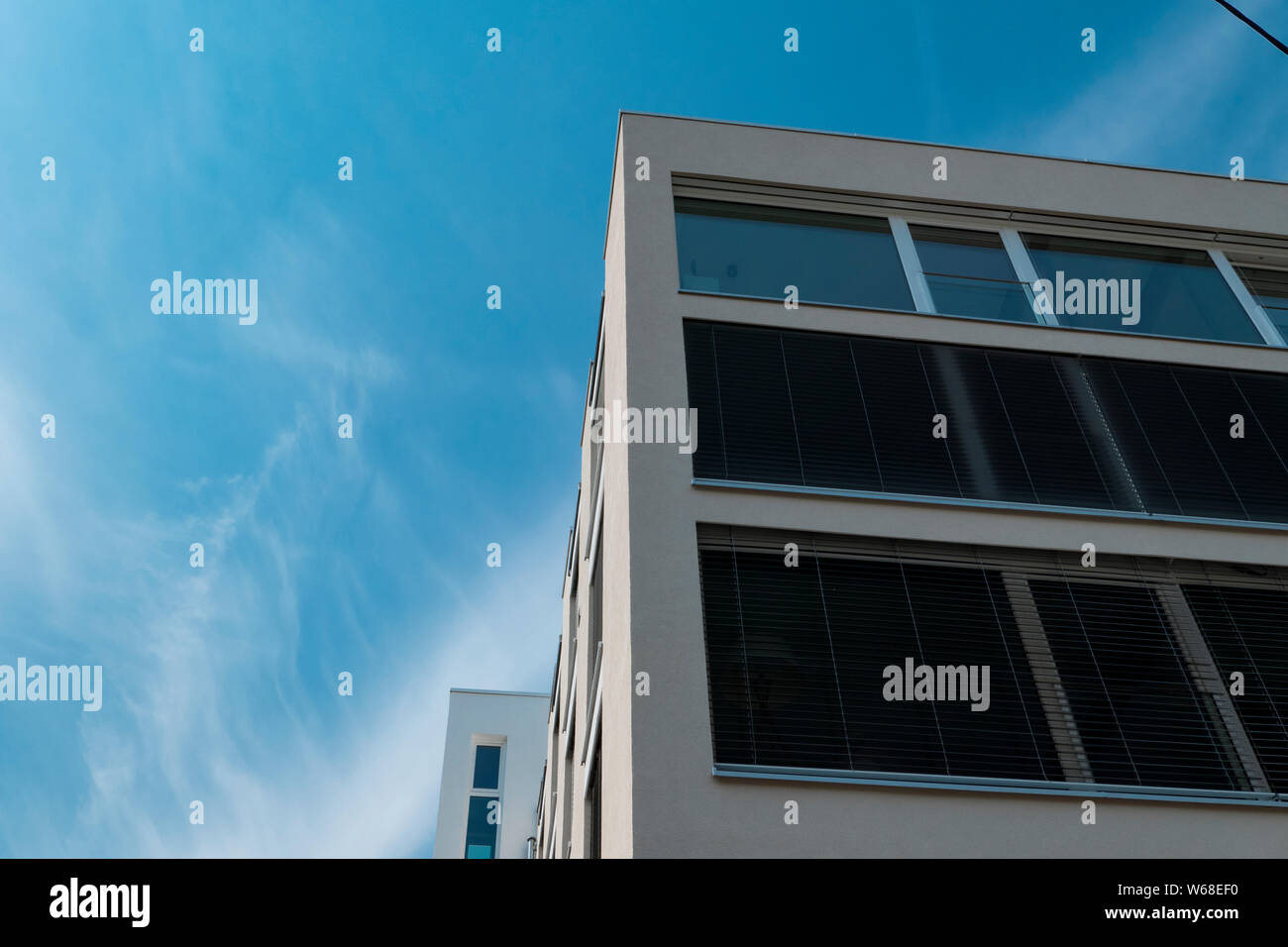 modern angular house facade with large windows and blue sky Stock Photo ...