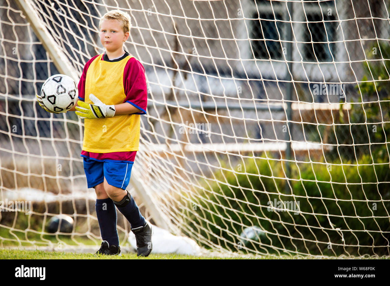 Young boy in goalkeeper position during a soccer game Stock Photo - Alamy