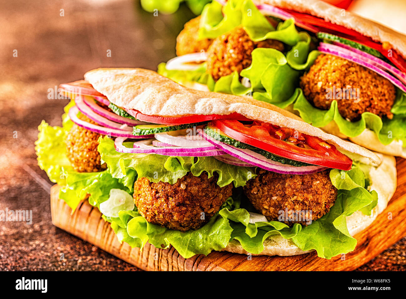 Falafel and fresh vegetables in pita bread on dark background Stock ...