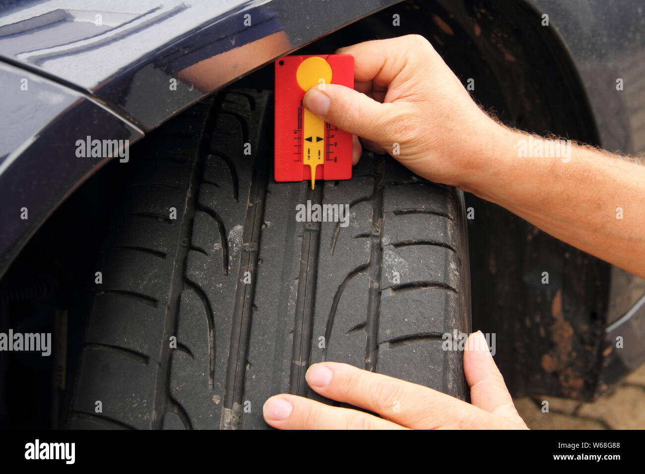 Measuring summer tire profile Stock Photo - Alamy