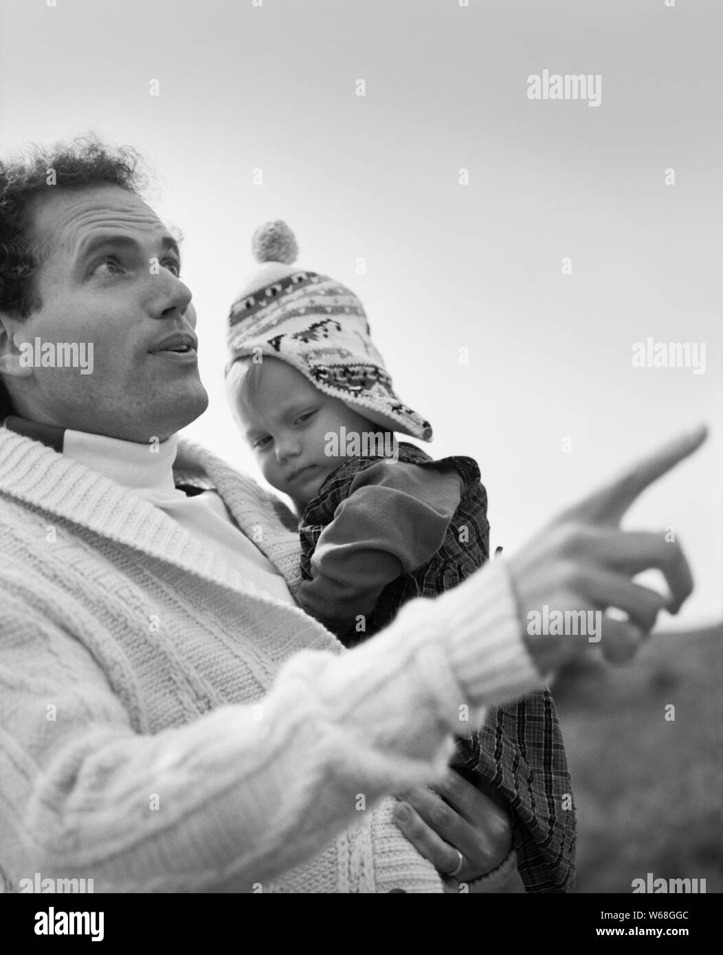Man pointing and holding his toddler daughter Stock Photo - Alamy