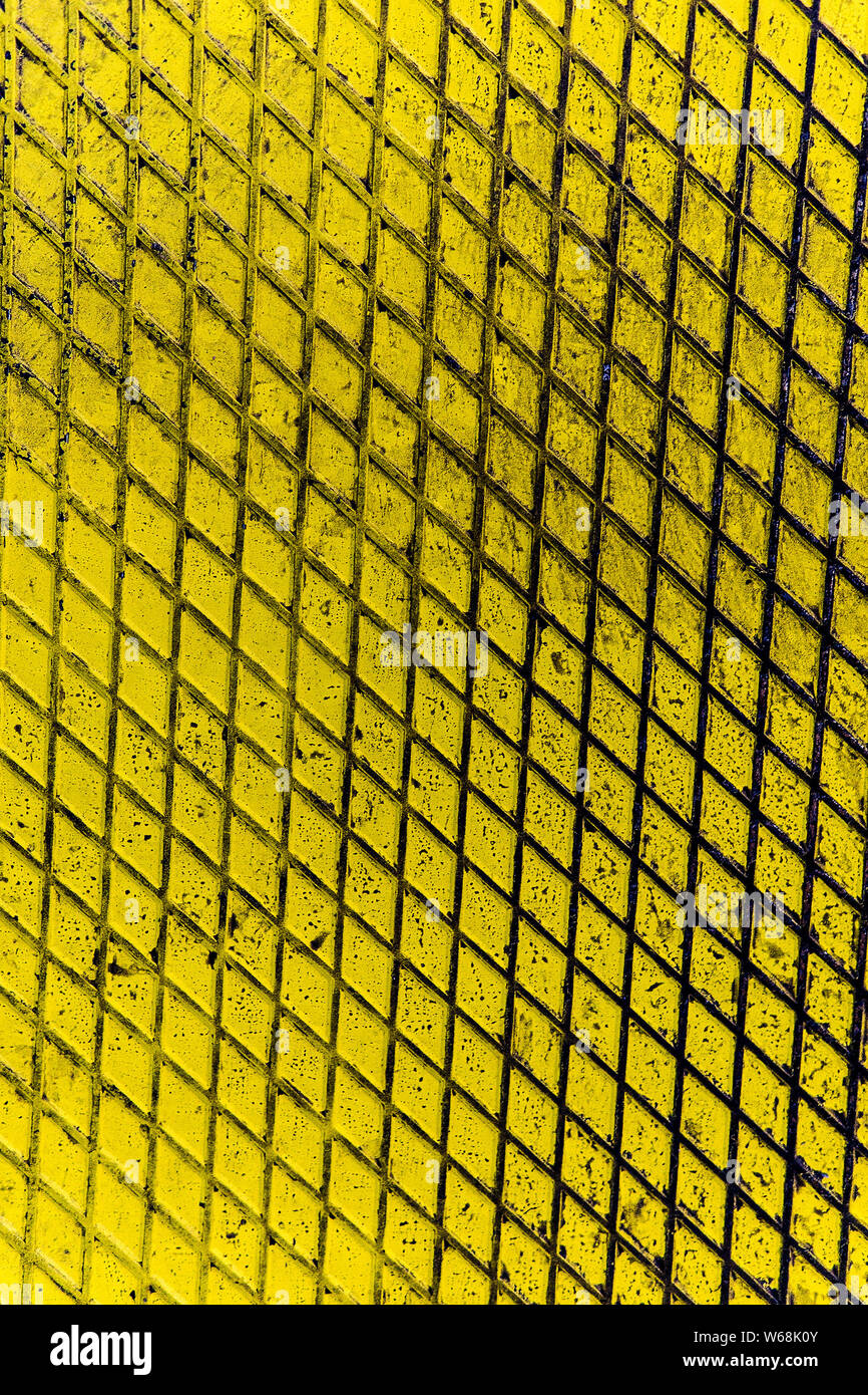 Corrugated yellow metal surface with diamond plate texture. The diamond ...