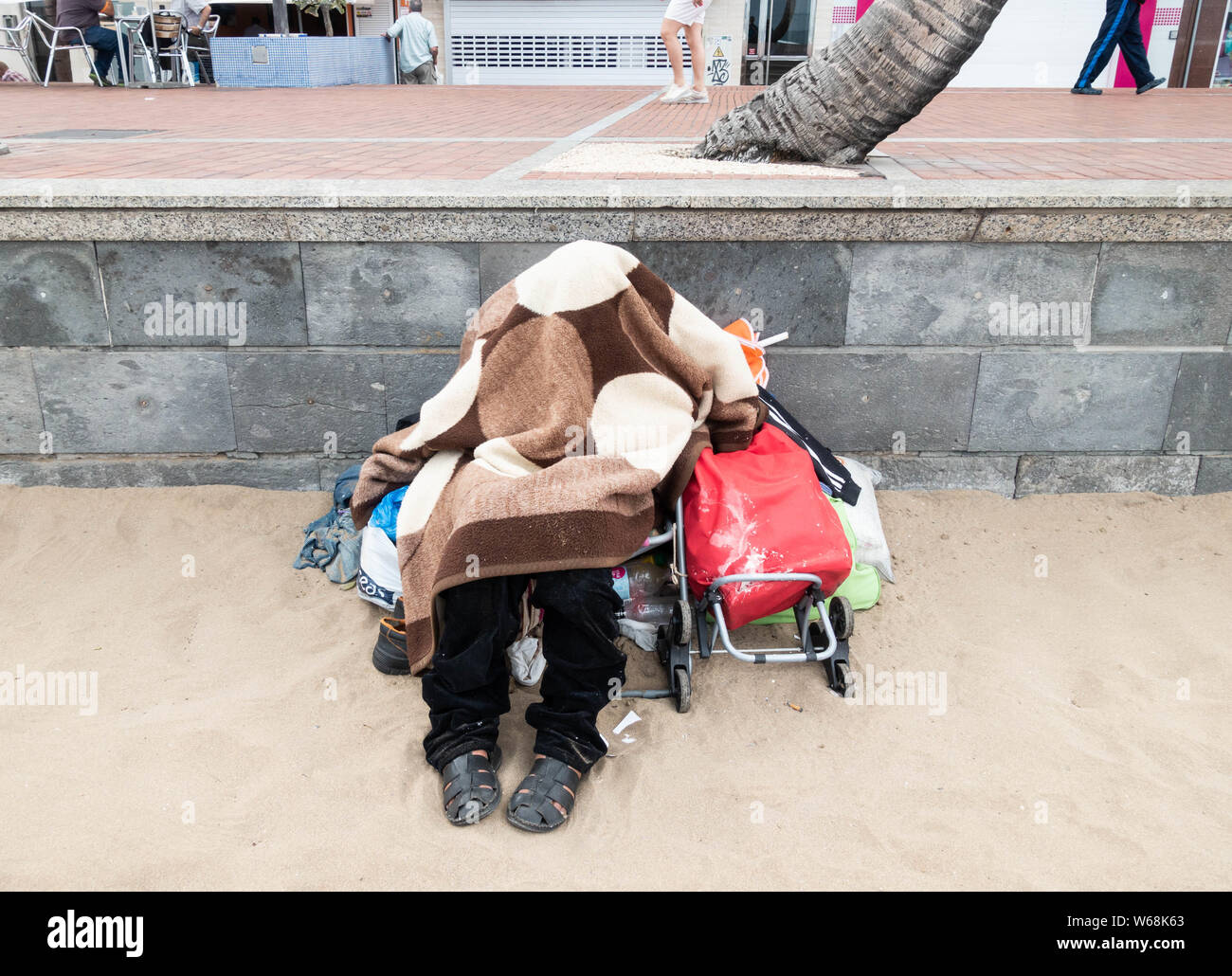 Homeless person sleeping on beach in Spain Stock Photo - Alamy