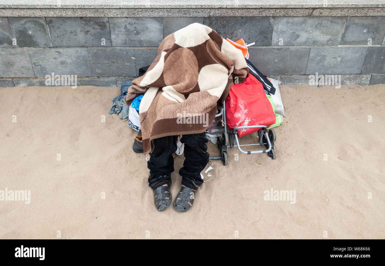 Homeless man sleeping on beach hi-res stock photography and images - Alamy