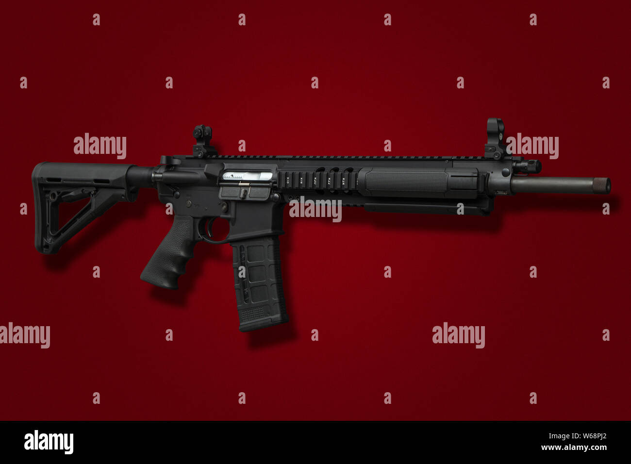 Modern automatic rifle isolated on red background Stock Photo - Alamy