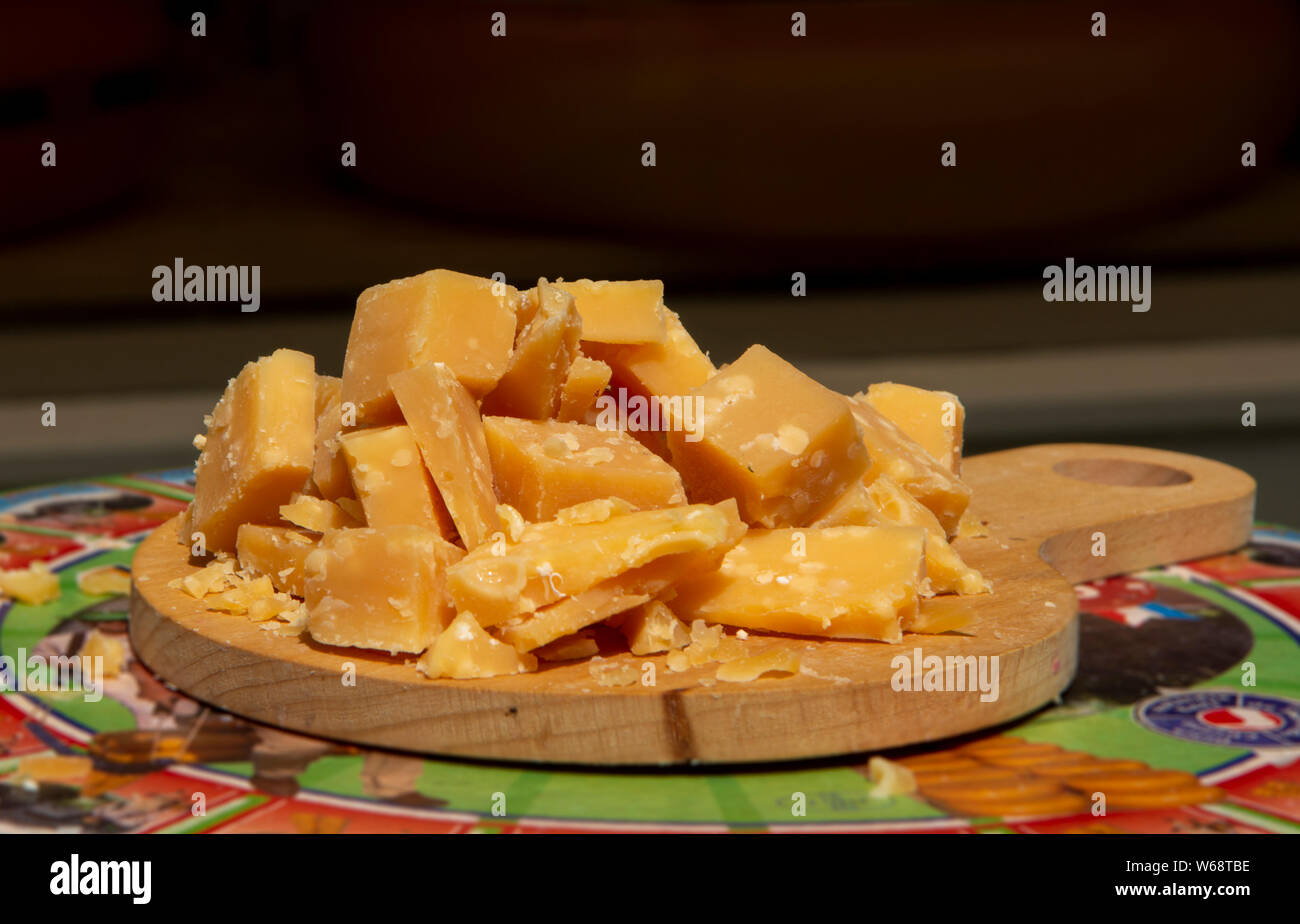 Tasting of old Dutch organic yellow cheese in blocks outside of cheese ...