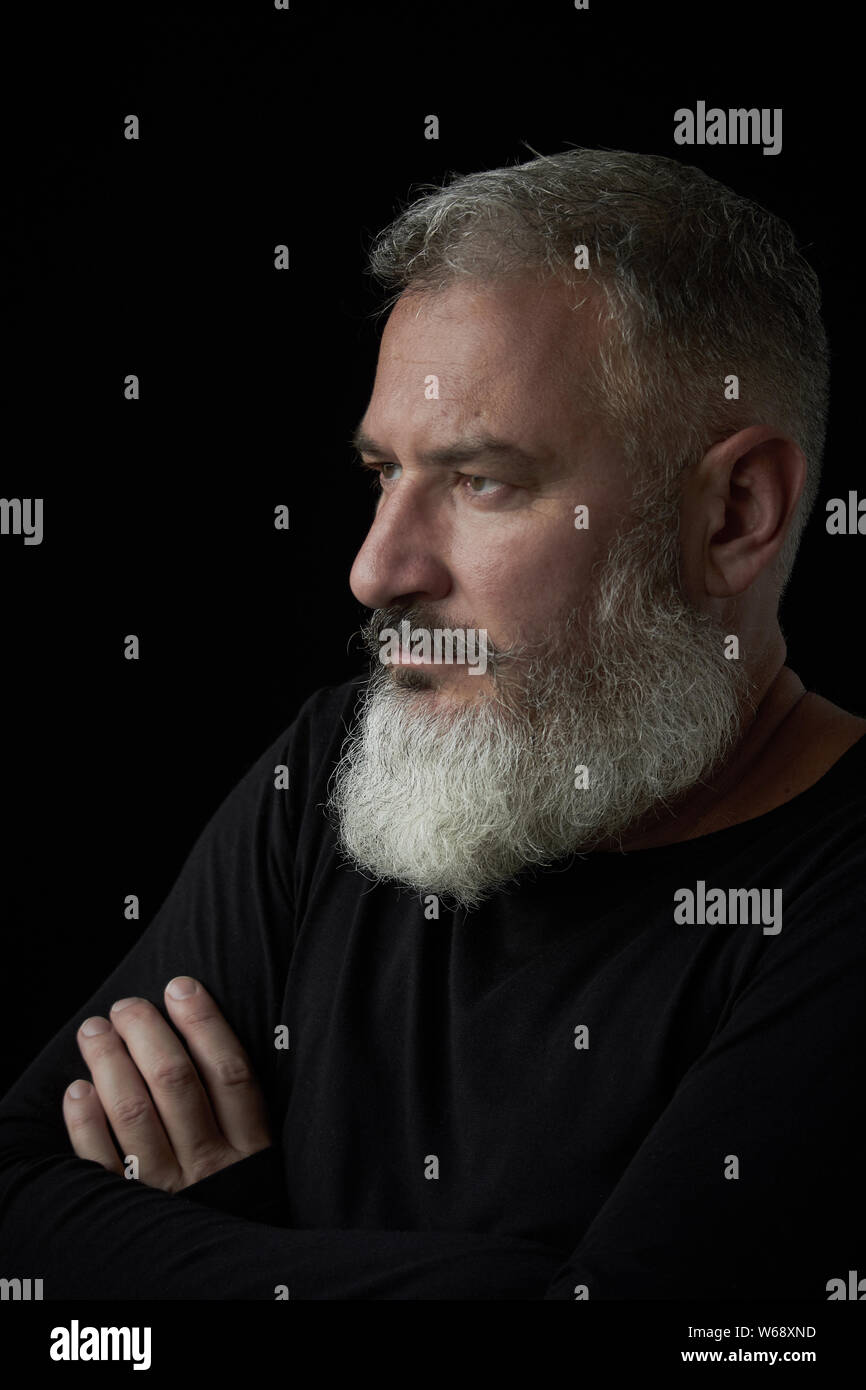 Portrait of brutal gray haired man with a gray lush beard and strict ...