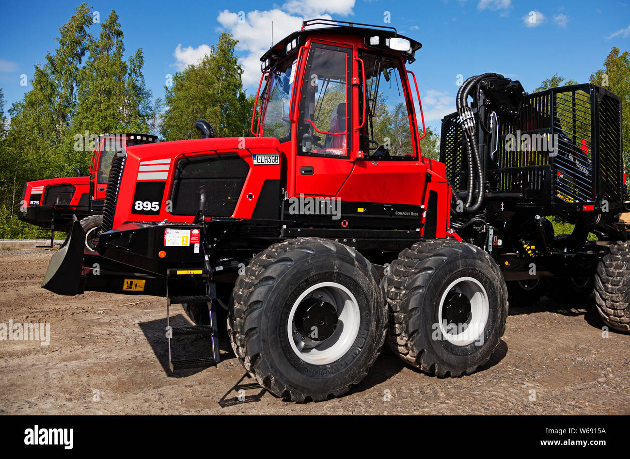 Umea, Sweden - Jun 10, 2019: Several red forest tractors in a row for ...
