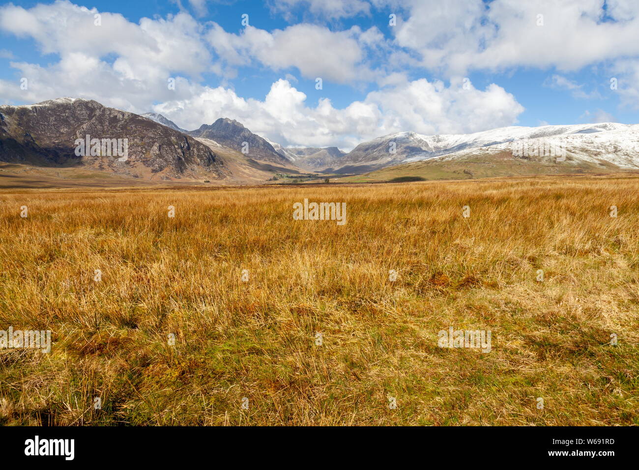 Looking up the Ogwen Valley towards the snow capped Carneddau and ...