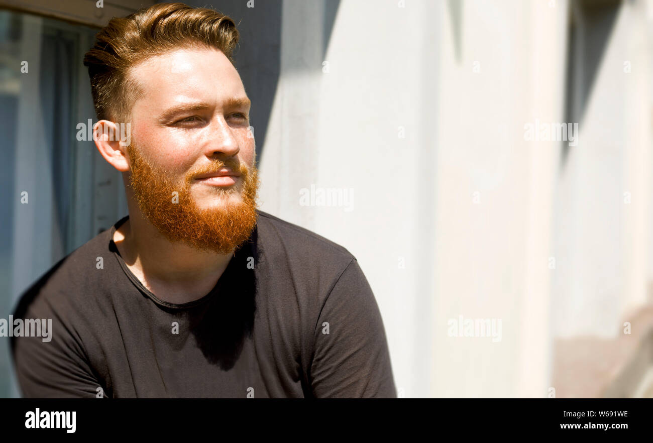 Portrait of an attractive redhead man with a beard. Close-up of a ...
