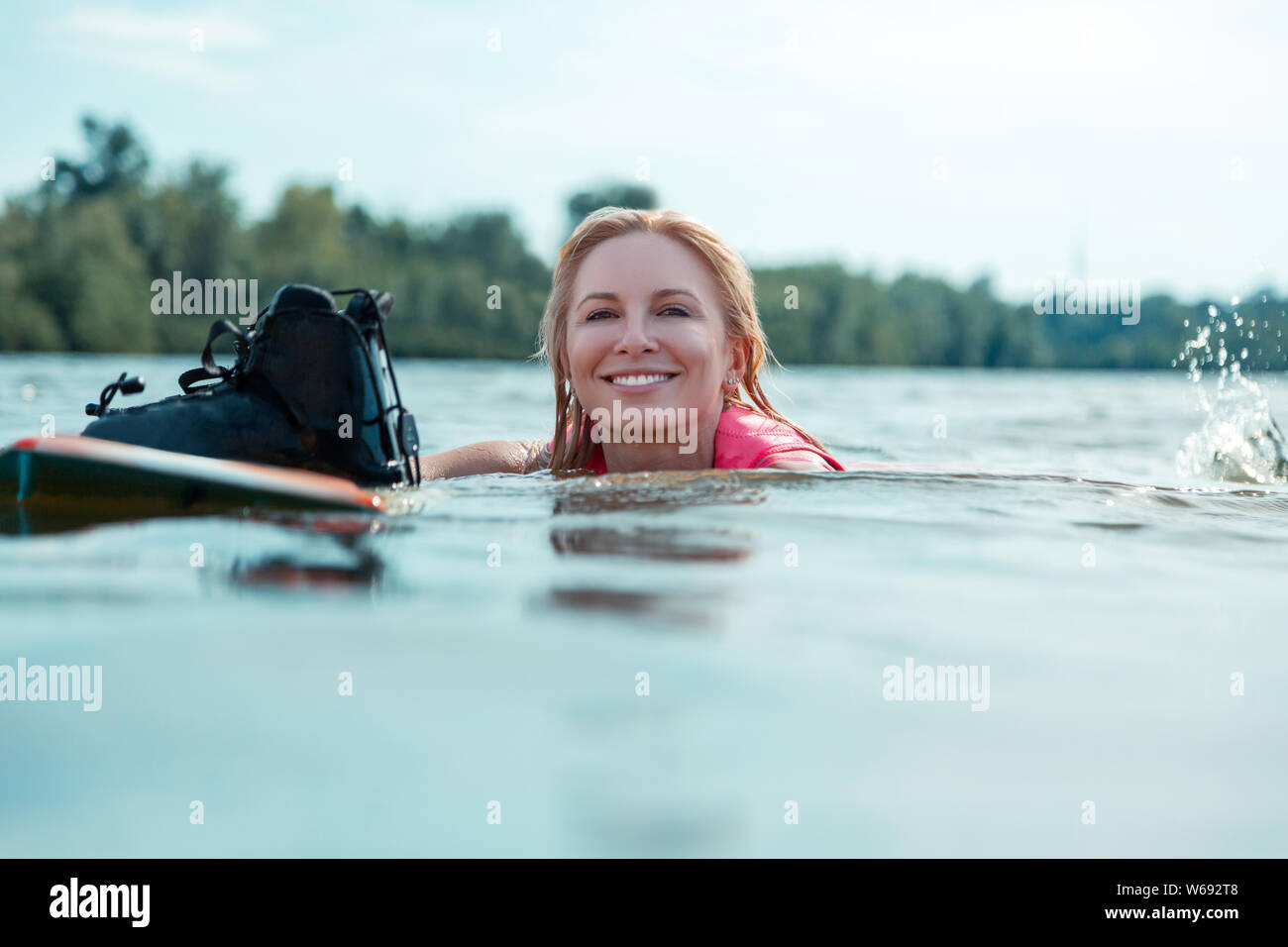 Beautiful smiling Caucasian woman floating in the water Stock Photo - Alamy