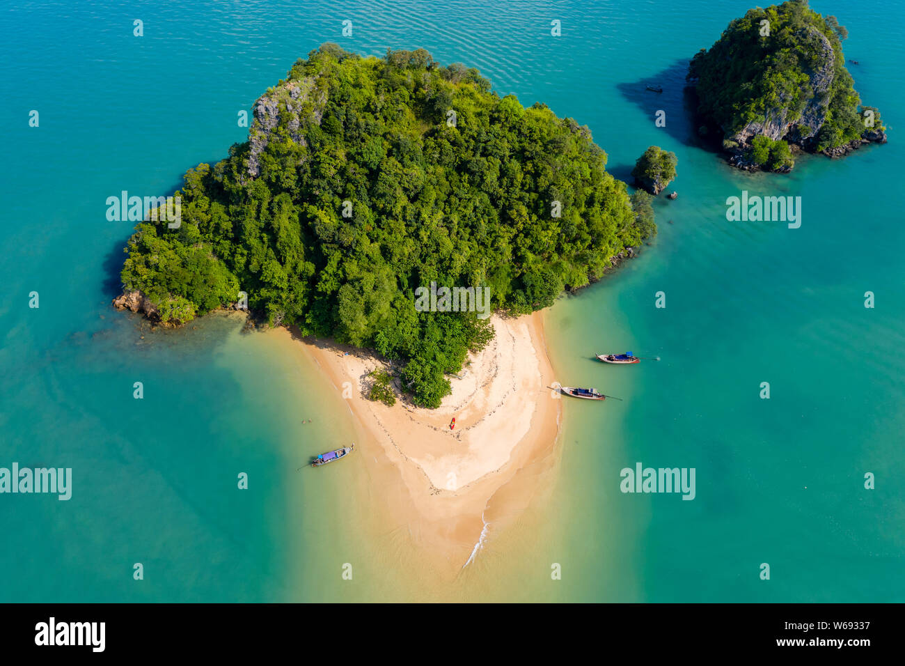 Aerial drone view of an exotic, tiny tropical island with sandy beach ...
