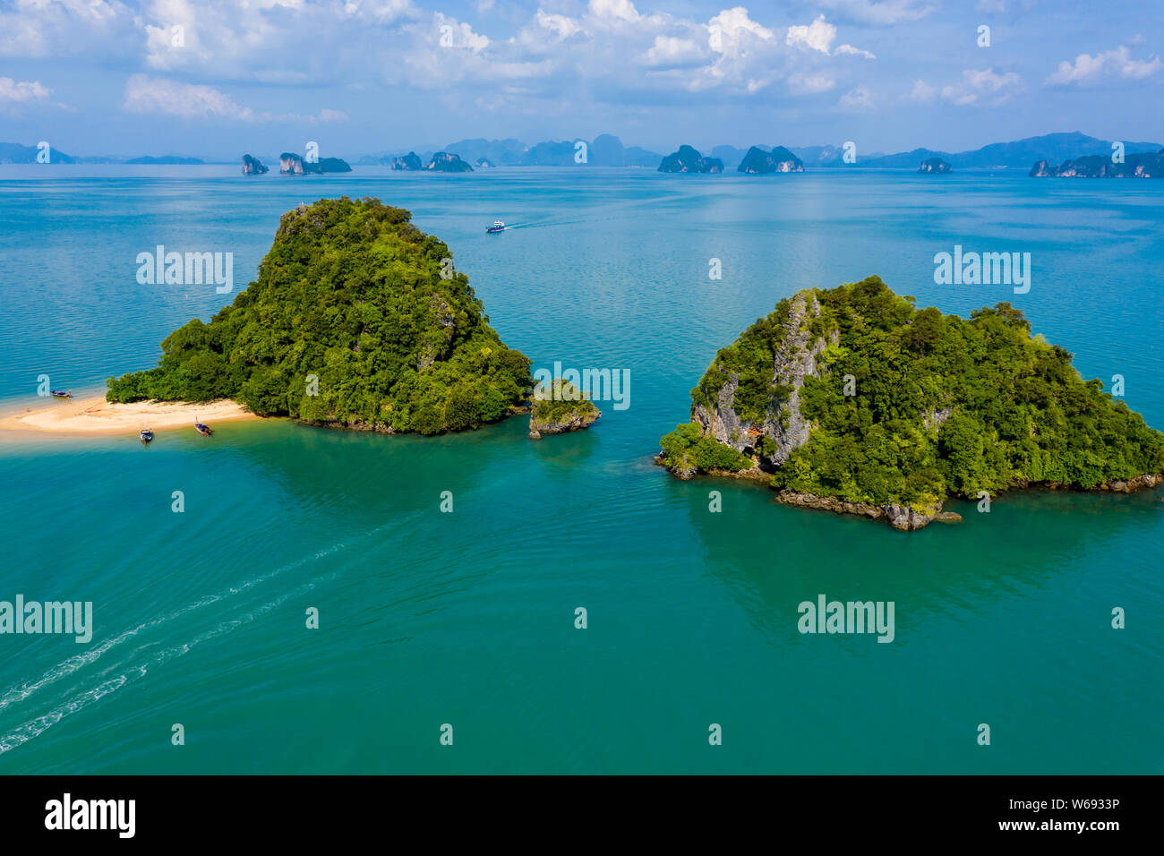 Aerial drone view of an exotic, tiny tropical island with sandy beach ...