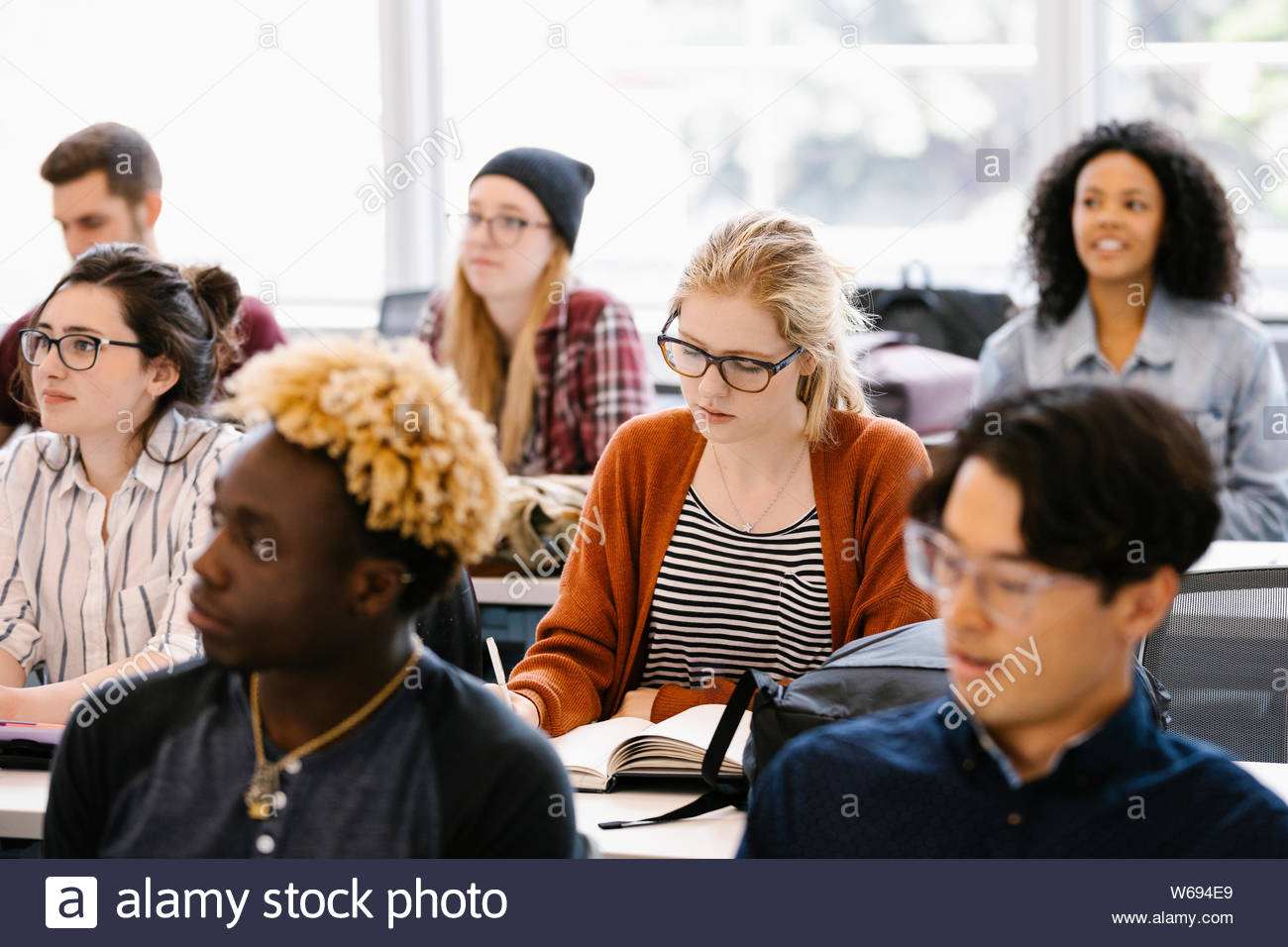 University students making notes and listening in classroom Stock Photo ...