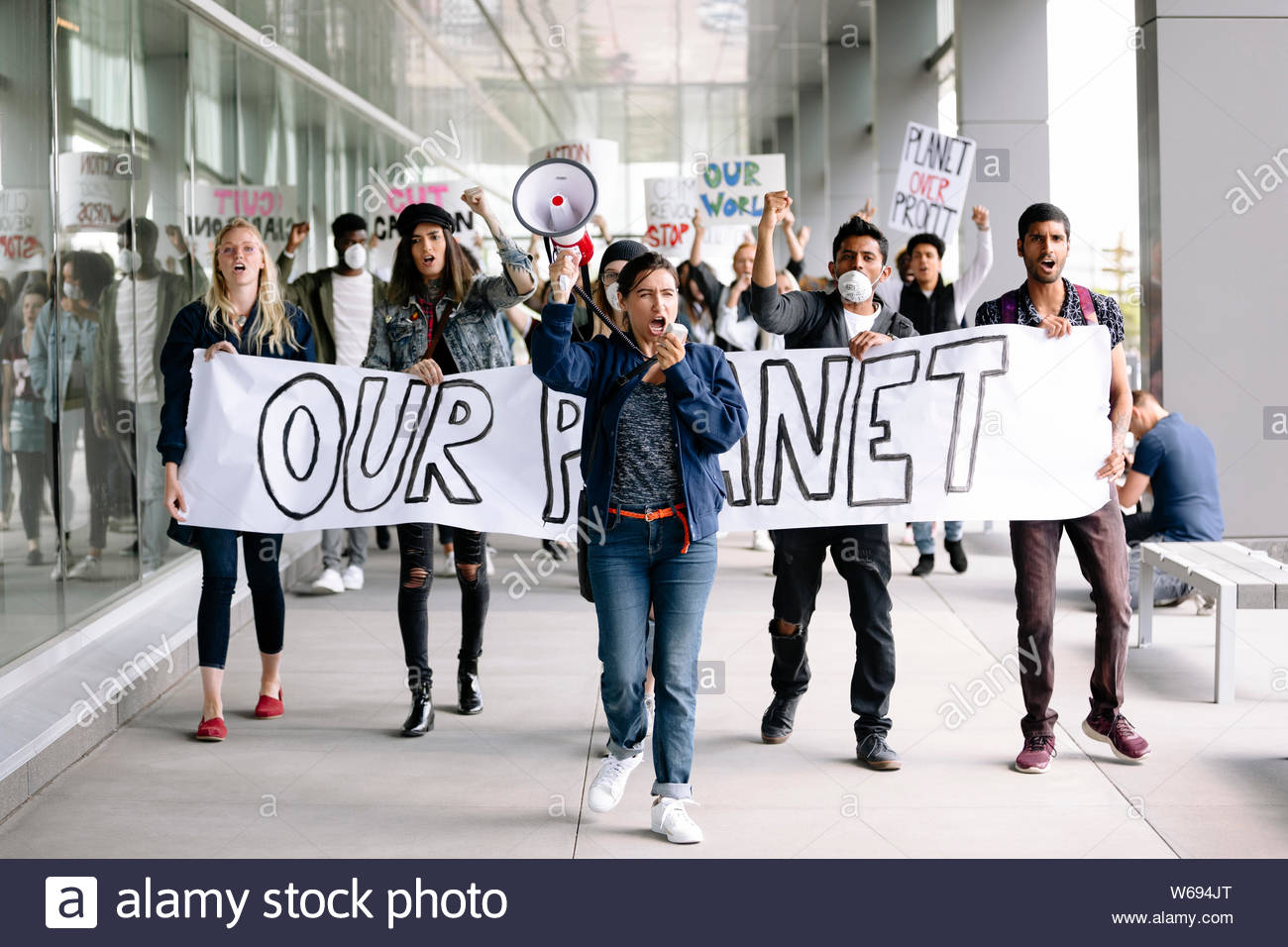 Student leading climate change march with megaphone Stock Photo - Alamy