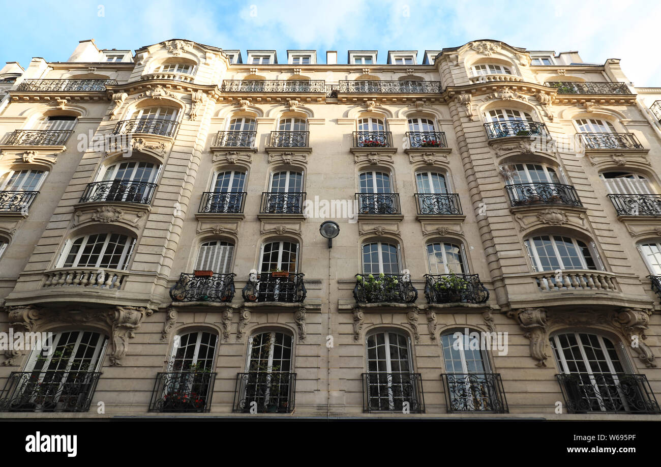 Traditional French house with typical balconies and windows. Paris ...