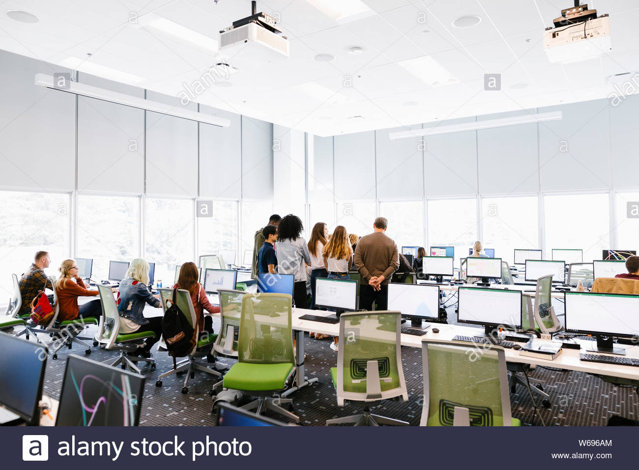 Young students around computer hi-res stock photography and images - Alamy