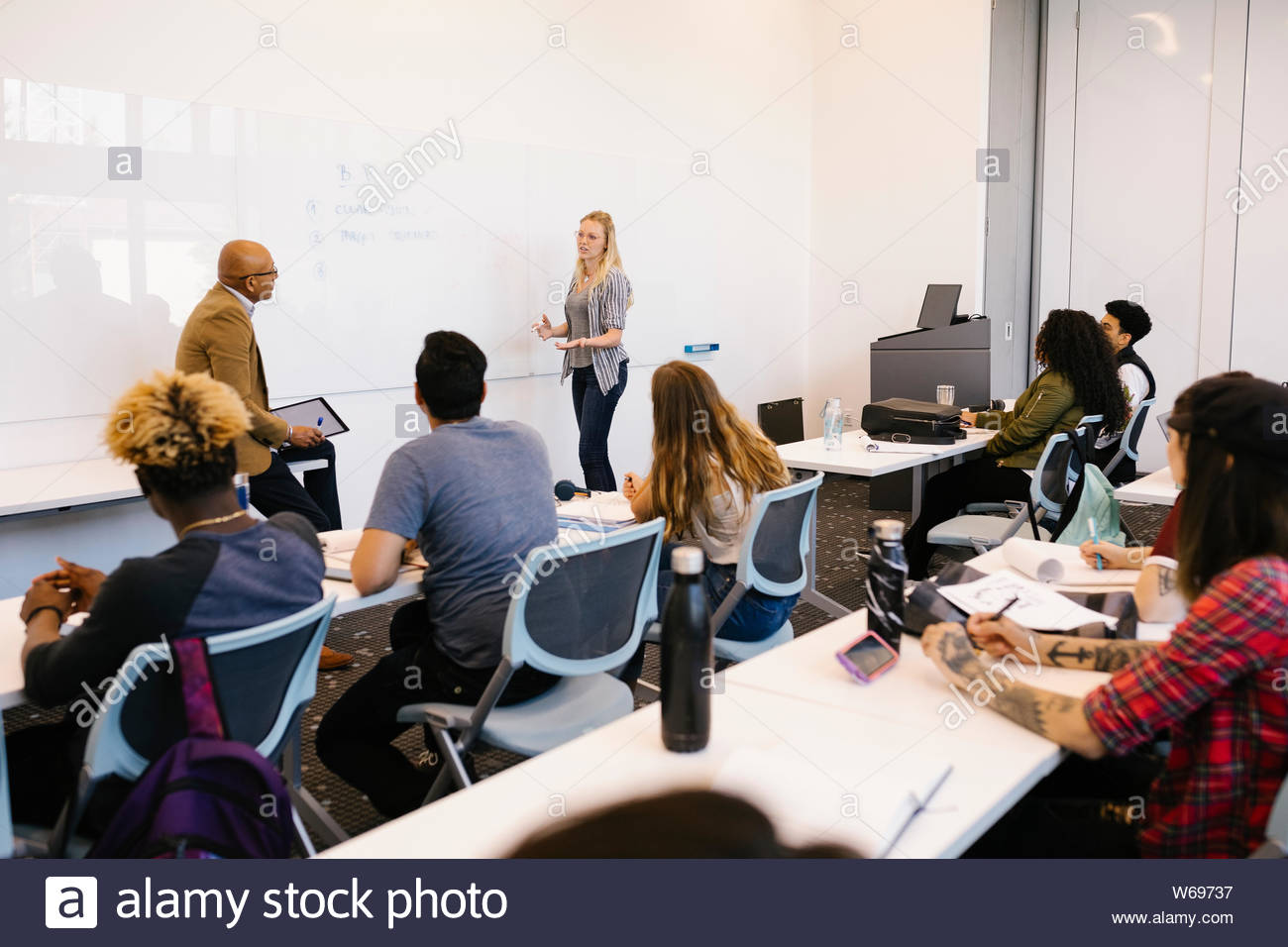Female teacher giving lecture hi-res stock photography and images - Alamy
