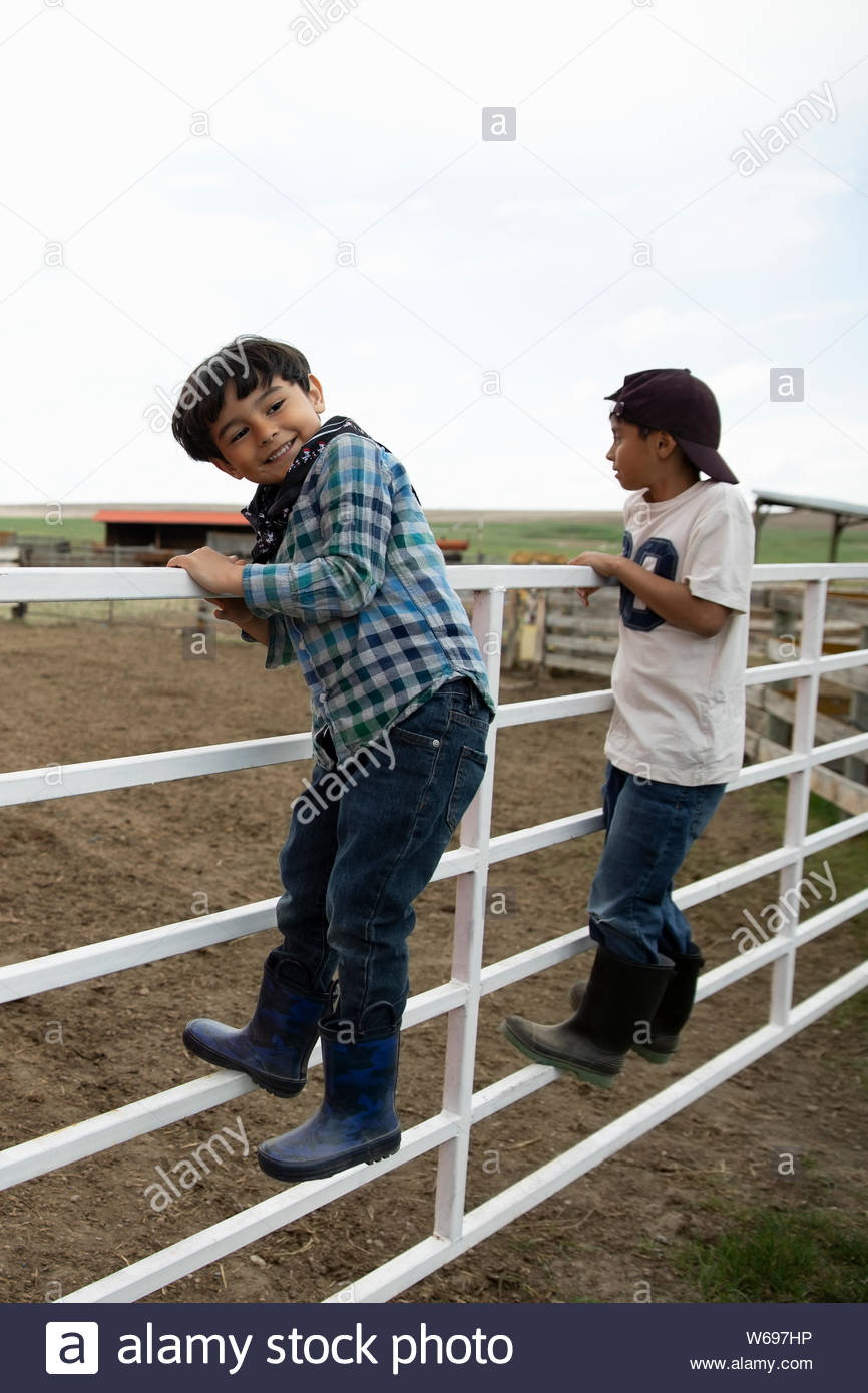 Boy leaning over fence hi-res stock photography and images - Alamy