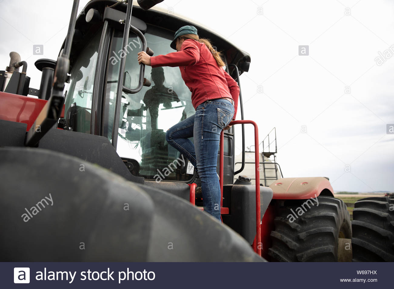 Farmer climbing tractor hi-res stock photography and images - Alamy