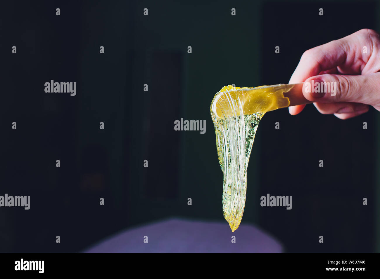 Sugaring. Beauty Concept. Young beautiful girl with dark hair gets the ...