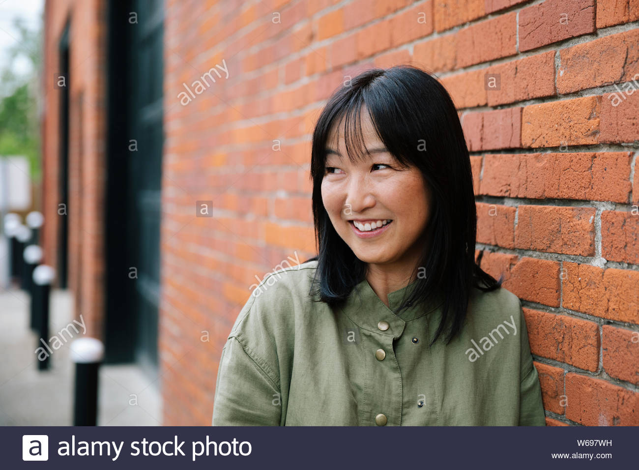 Person posing and brick wall hi-res stock photography and images - Alamy