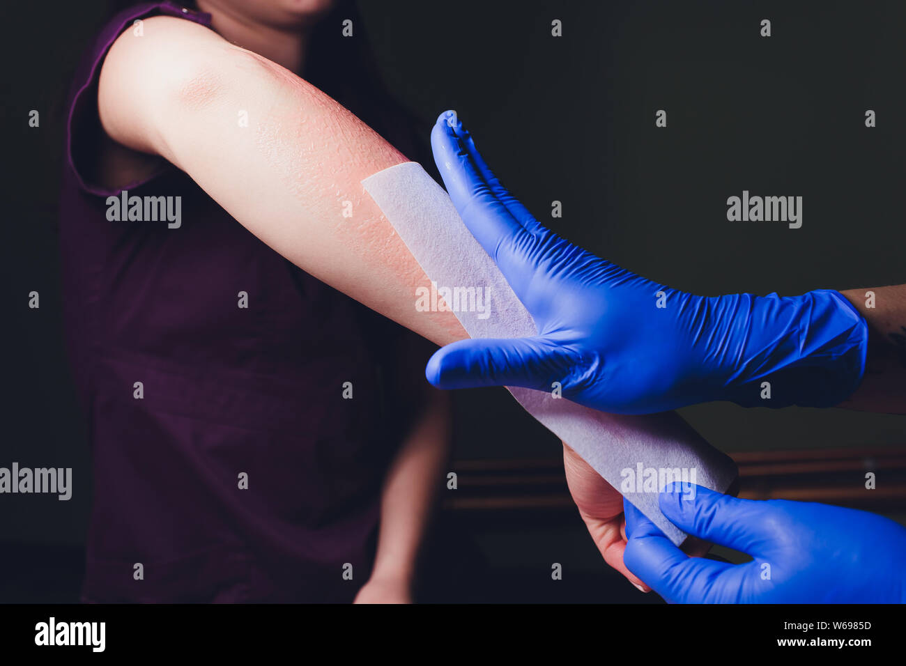 Sugaring. Beauty Concept. Young beautiful girl with dark hair gets the ...