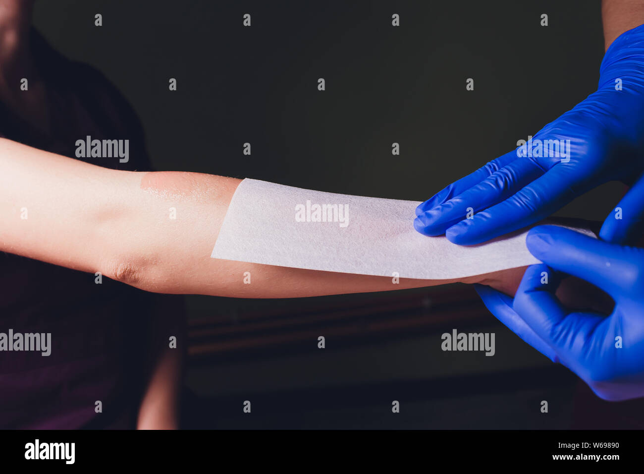 Sugaring. Beauty Concept. Young beautiful girl with dark hair gets the ...