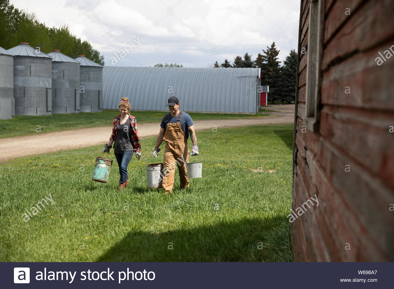 Men carrying buckets hi-res stock photography and images - Alamy