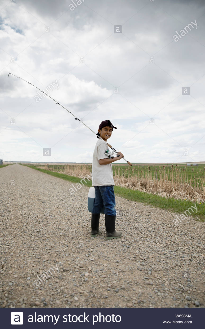 Boy holding fishing rod hi-res stock photography and images - Alamy