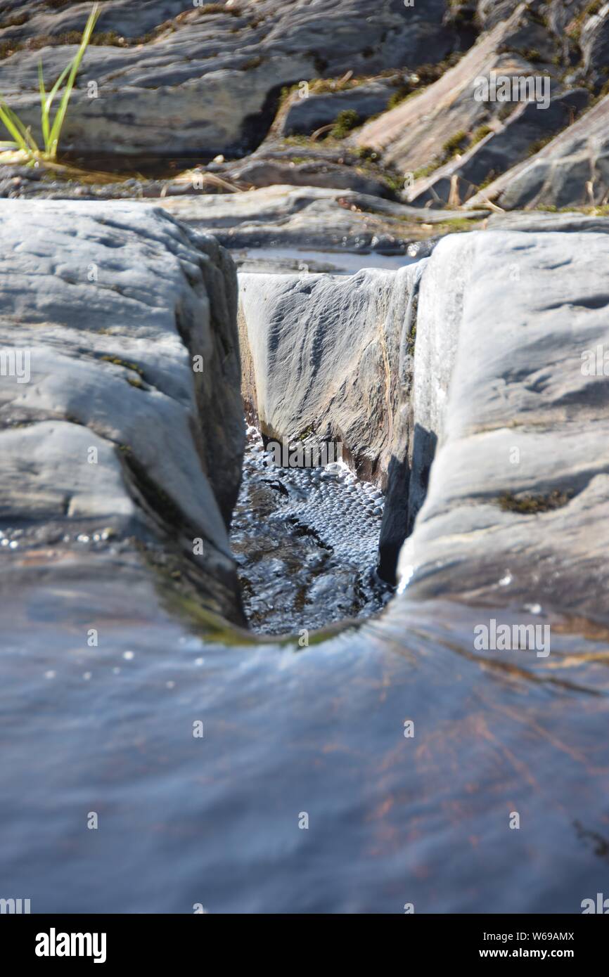 Small Water fall in the gap between the rocks Stock Photo - Alamy