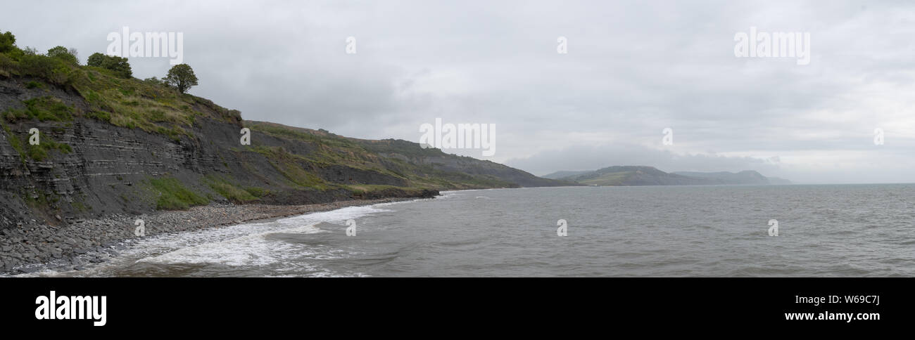 Panoramic photo of the cliffs at Lyme Regis beach in Dorset which if ...