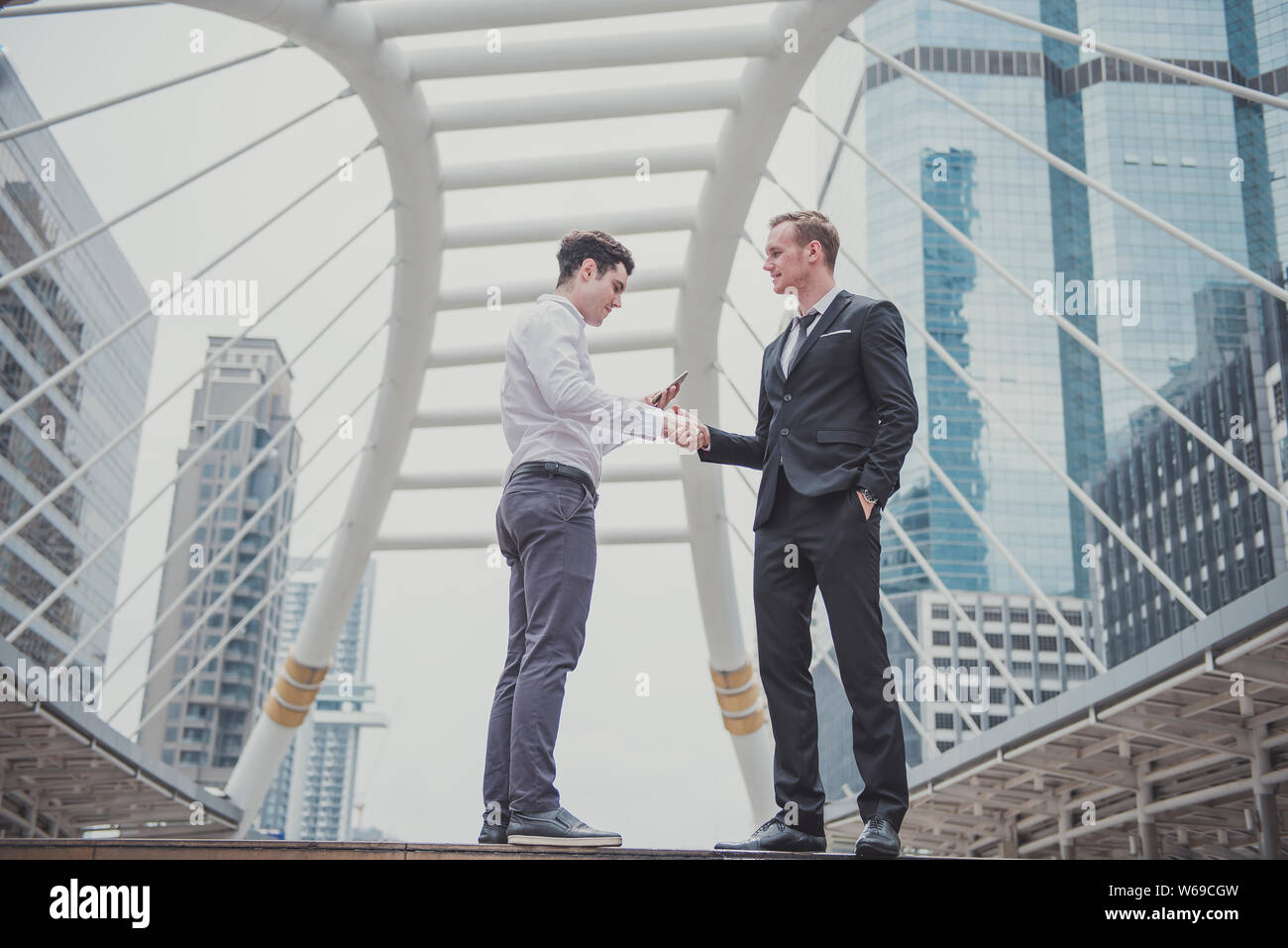 Young businessmen shaking hands with his boss Stock Photo - Alamy
