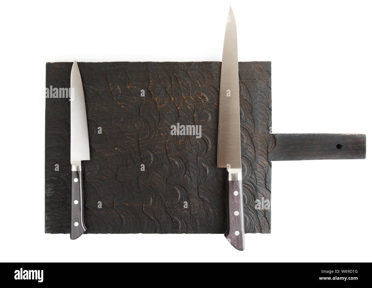 Two kitchen knives on black wooden board shot from above, isolated ...