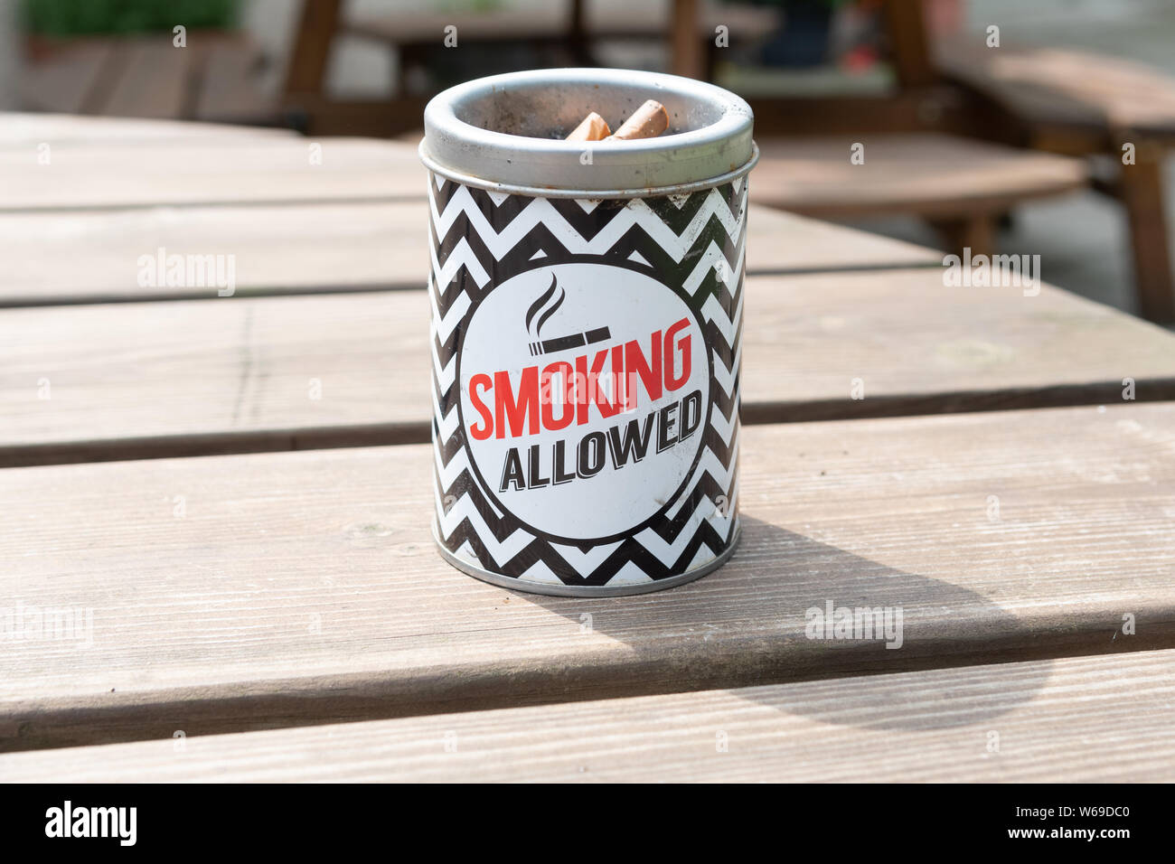 smoking allowed ash bucket in pub beer garden, UK Stock Photo - Alamy