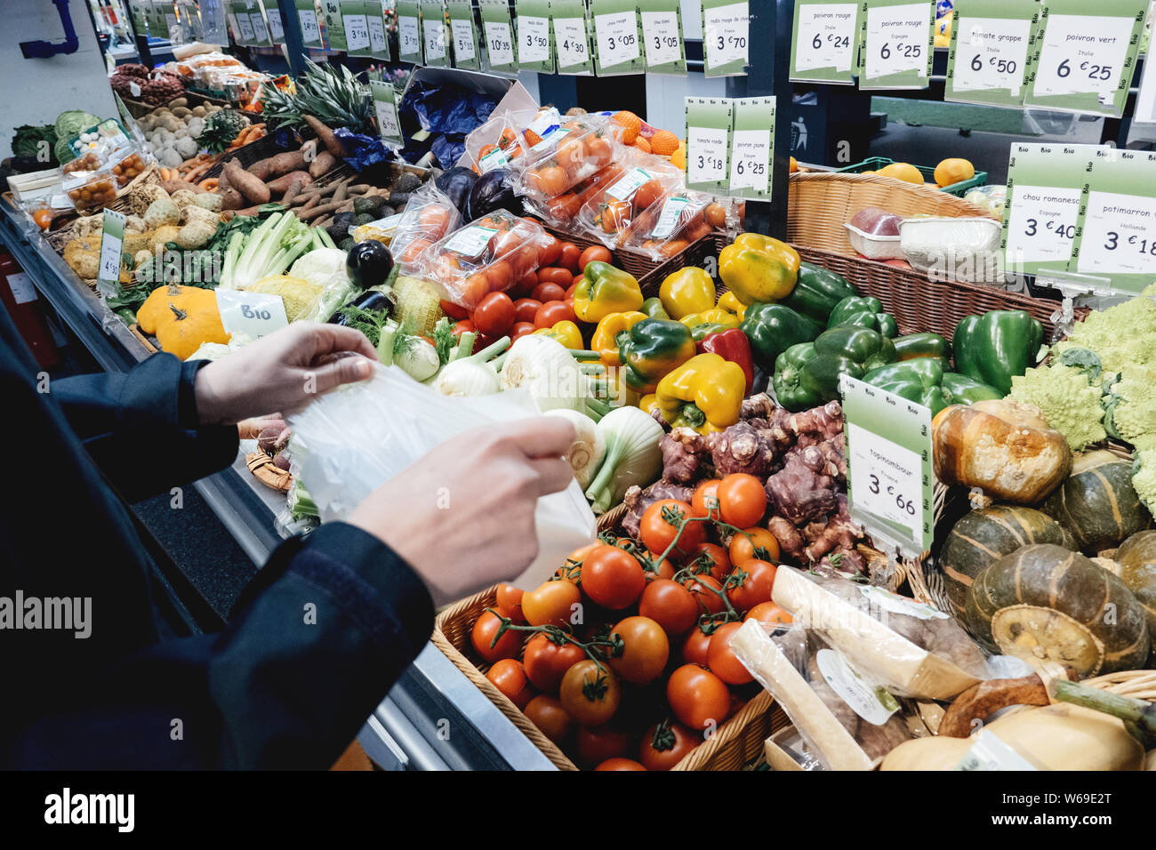 Side view of woman shopping for fresh food in the modern supermarket ...