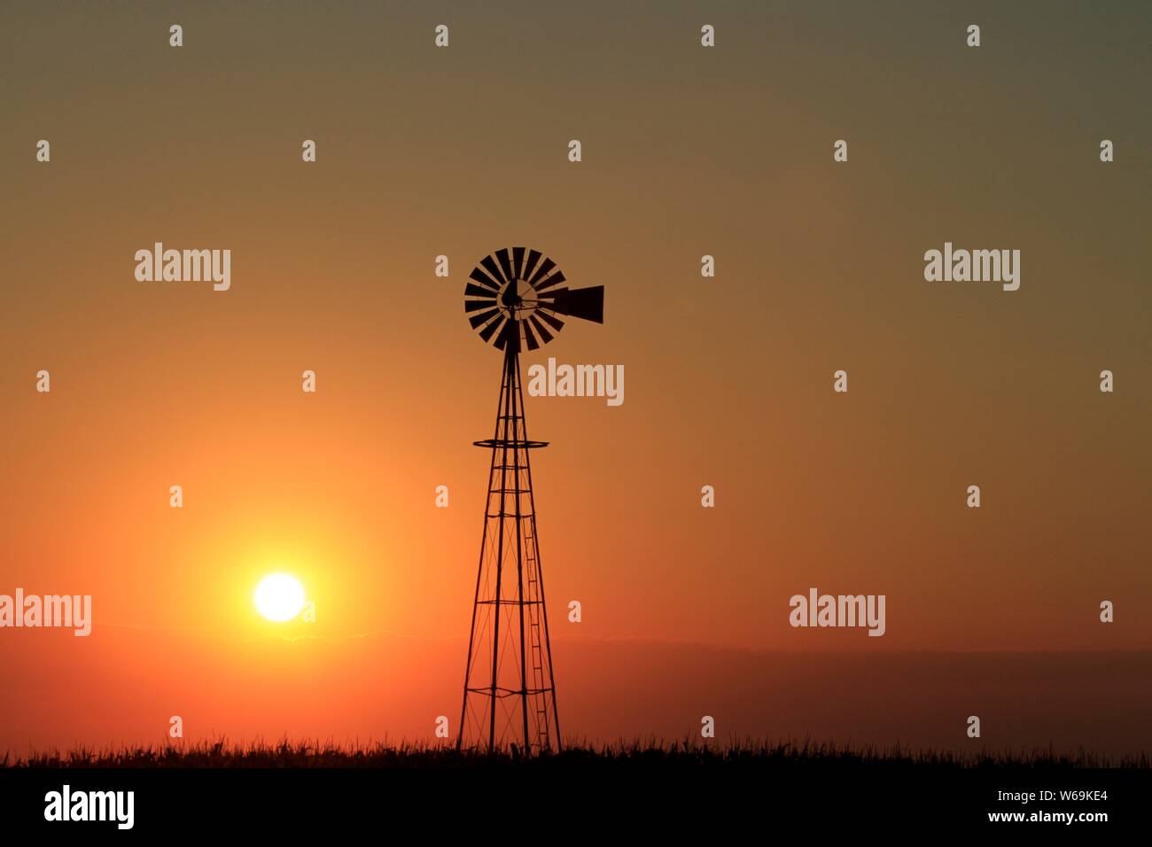 Kansas Windmill Silhouette with a colorful orange Blazing SUNSET ...