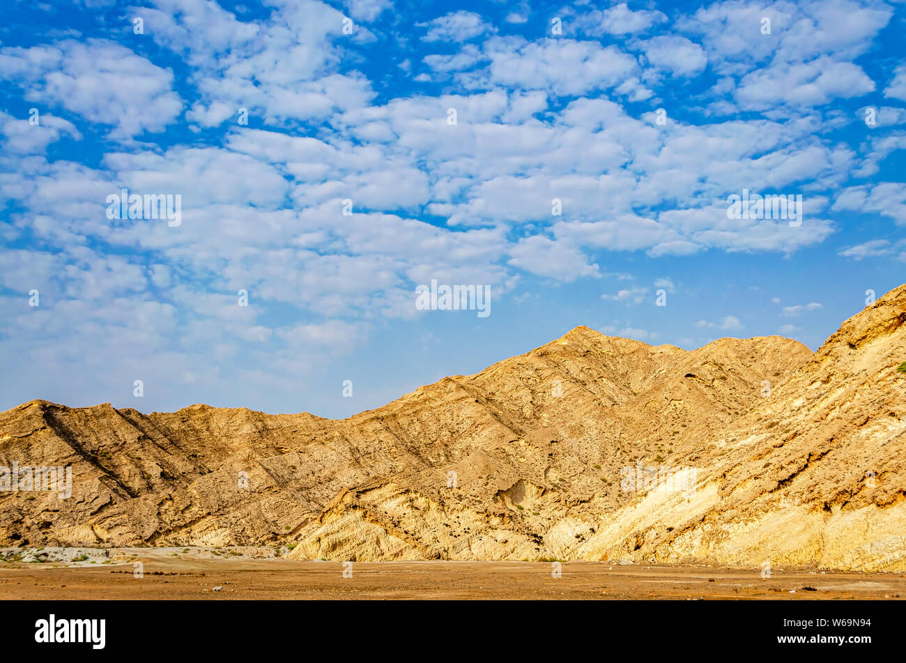 Orange Mountain range on a plateau with beautiful clouds as background ...