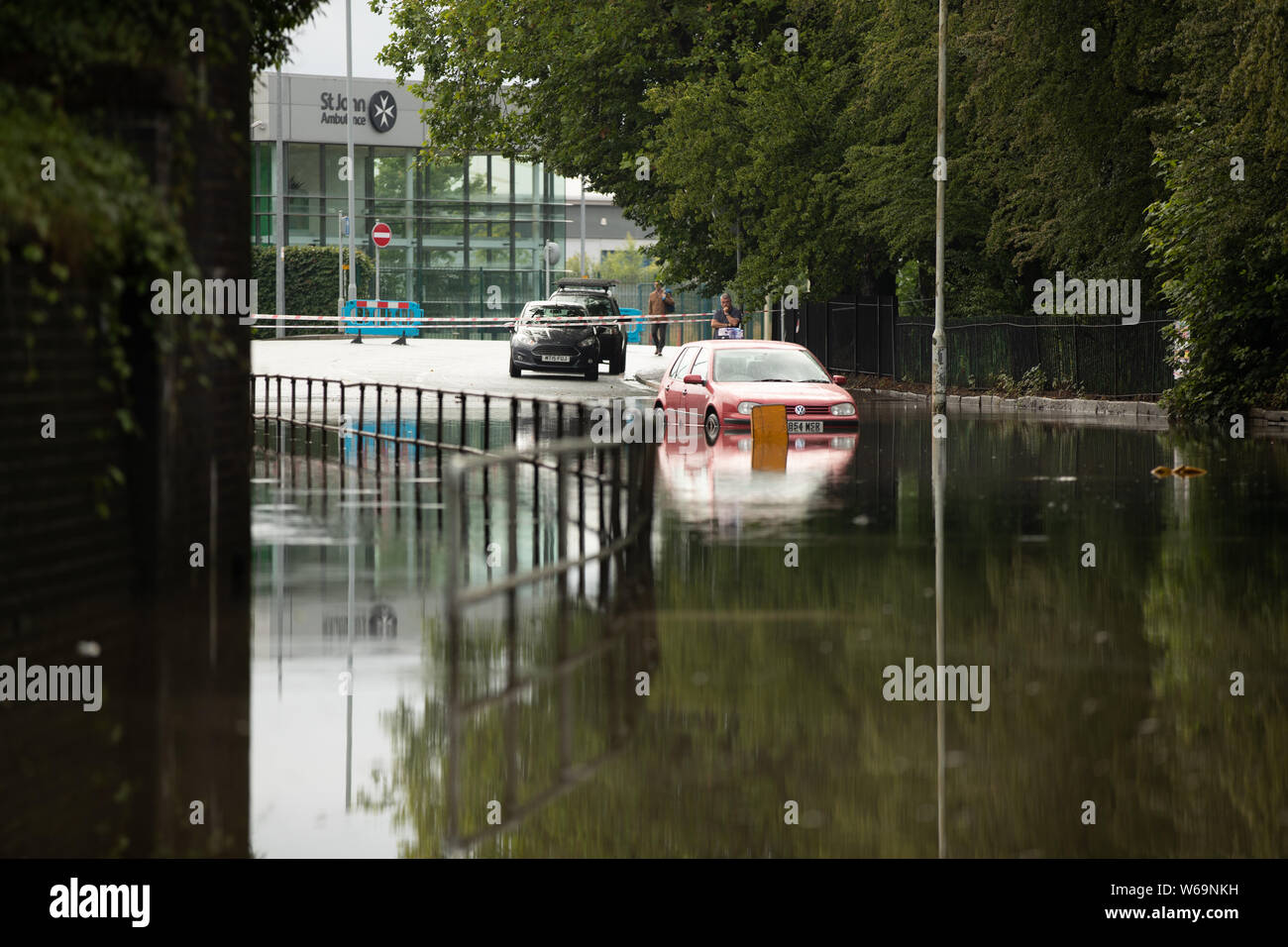Stockport, UK, 31 Jul 2019. A car stands abandoned in the dip of ...