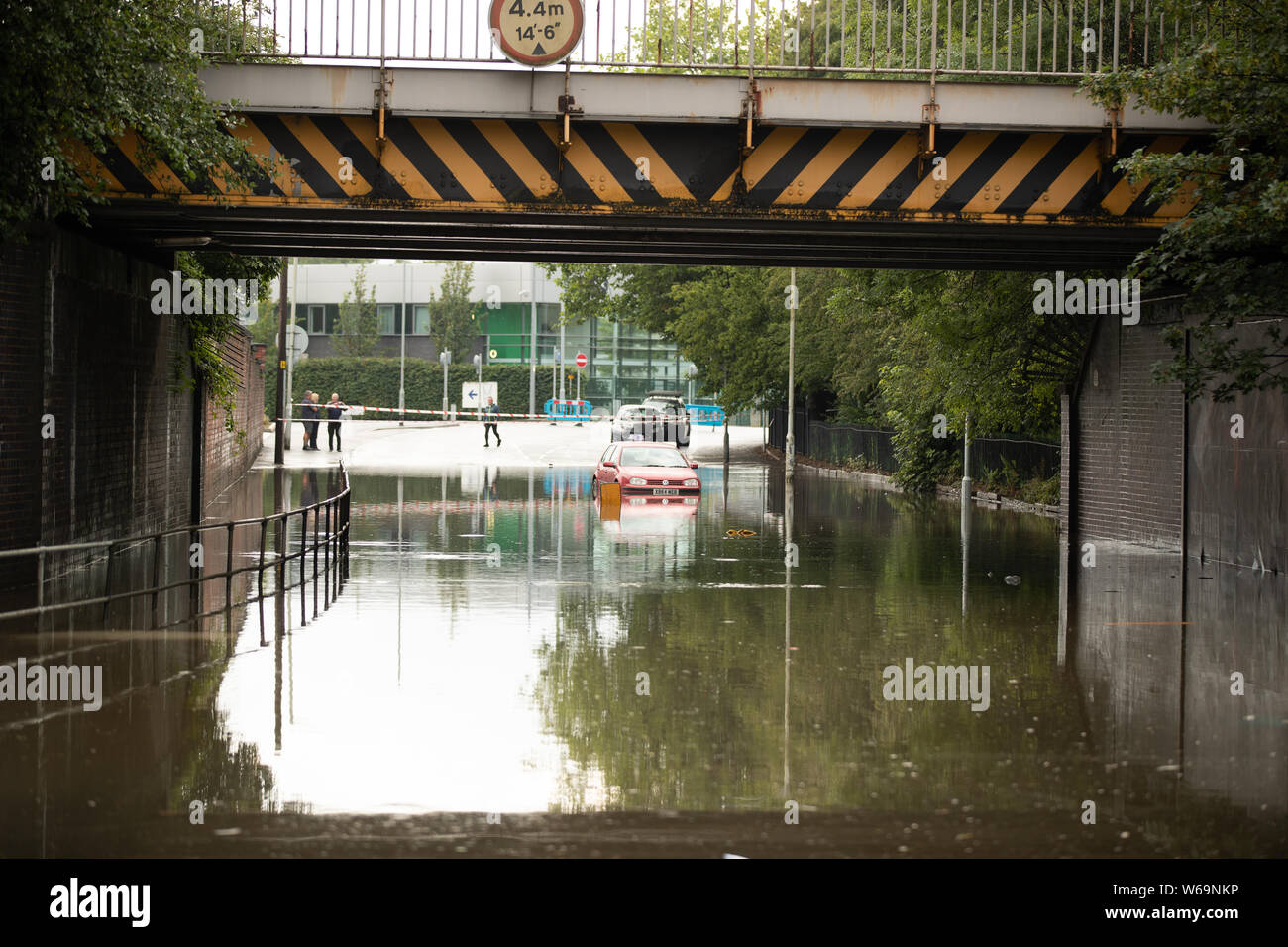 Stockport, UK, 31 Jul 2019. A car stands abandoned in the dip of ...