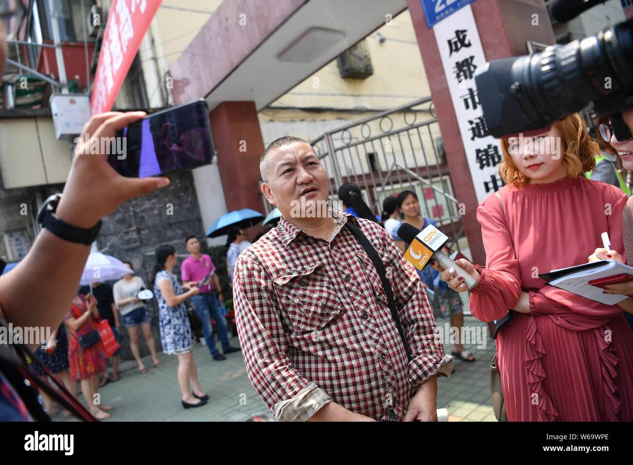 51-year-old Chinese man Liang Shi is interviewed after finishing his ...