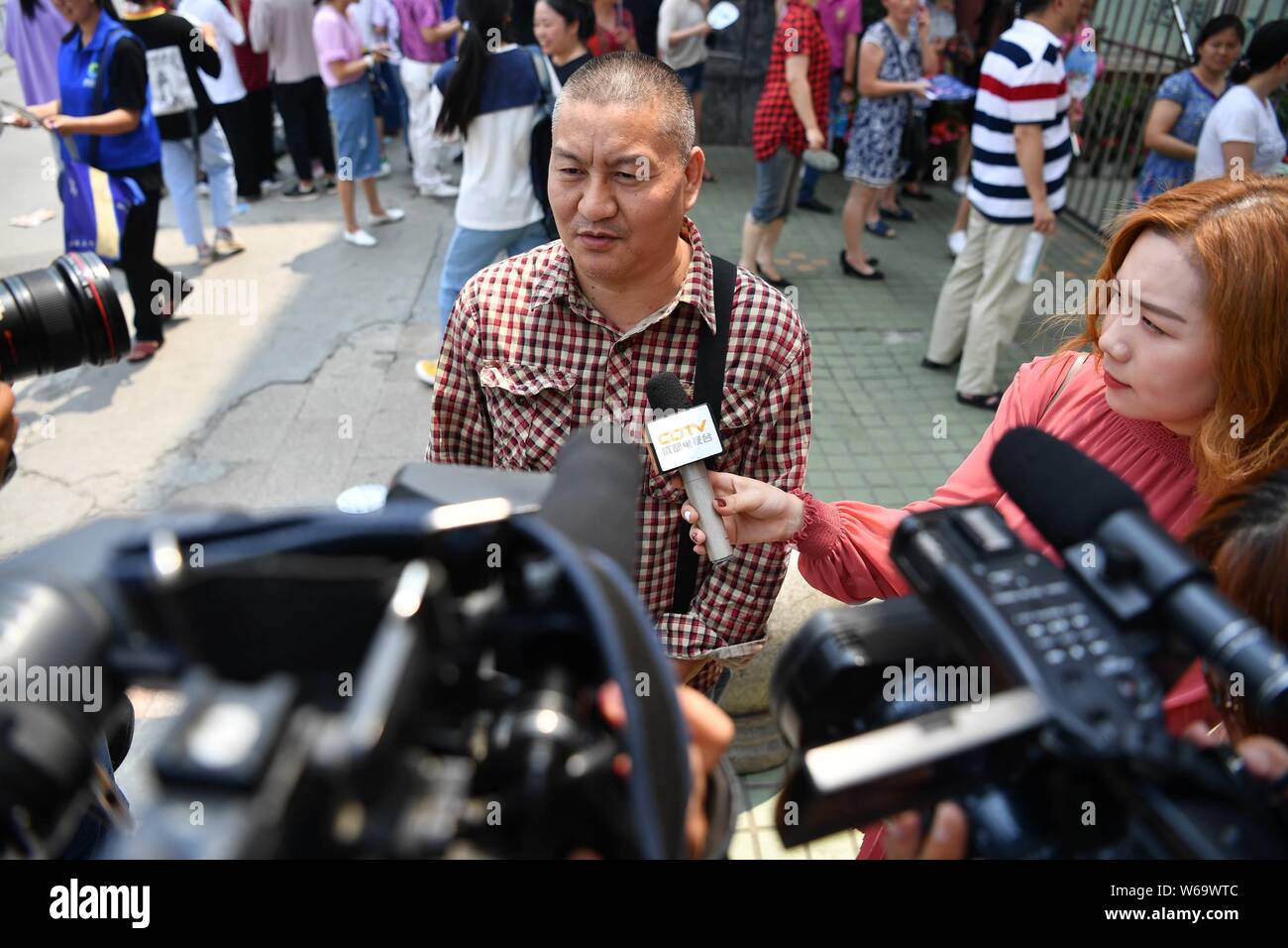 51-year-old Chinese man Liang Shi is interviewed after finishing his ...