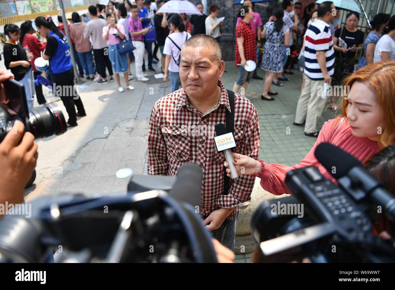 51-year-old Chinese man Liang Shi is interviewed after finishing his ...