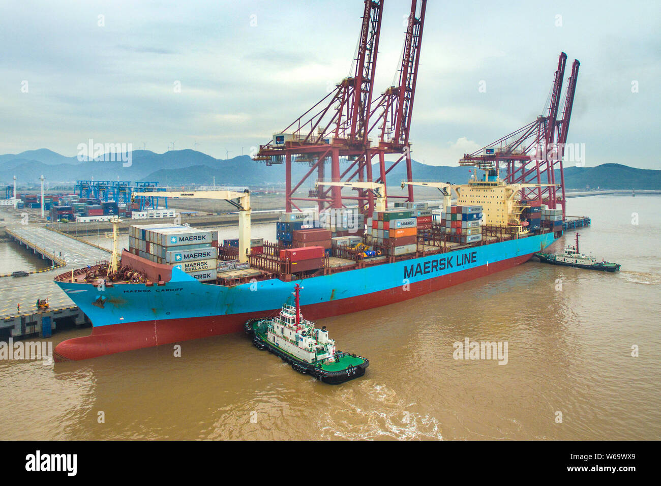 A cargo ship loaded with 1,690 twenty-foot equivalent units (TEUs) is ...