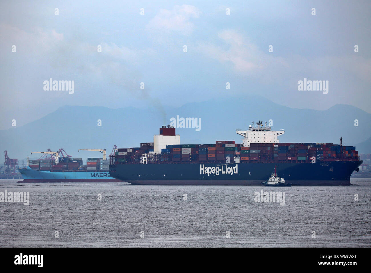 A cargo ship loaded with 1,690 twenty-foot equivalent units (TEUs) is ...