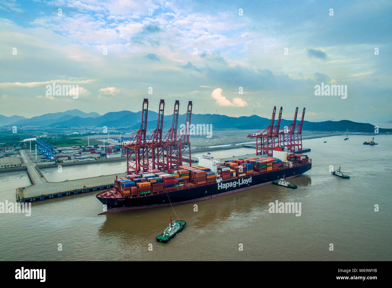 A cargo ship loaded with 1,690 twenty-foot equivalent units (TEUs) is ...