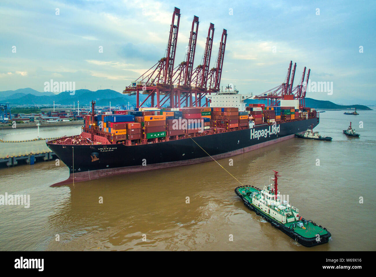 A cargo ship loaded with 1,690 twenty-foot equivalent units (TEUs) is ...